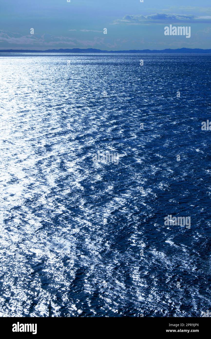 A view of the wide sea in the morning that sparkles in the sunlight ...