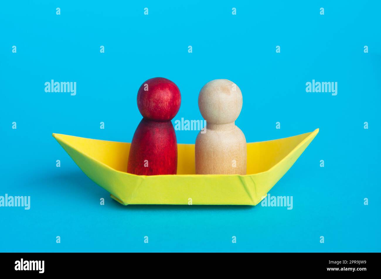 Couples on yellow paper ship with blue background. Relationship concept ...