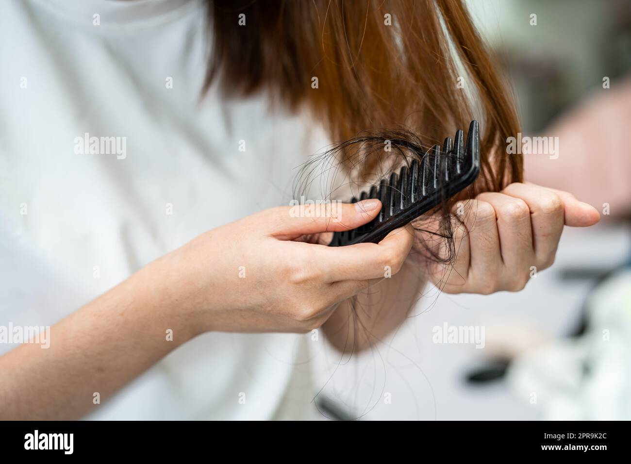 Asian woman have problem with long hair loss attach to comb brush Stock ...