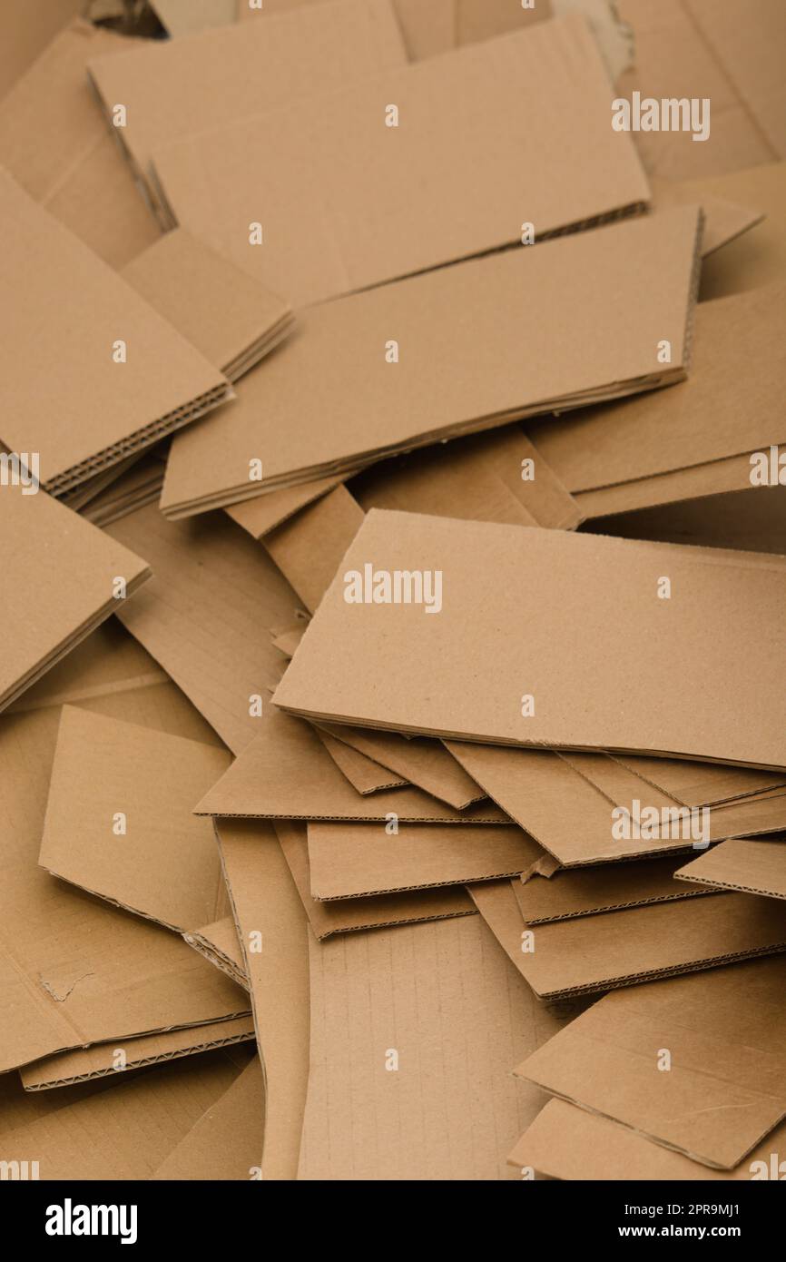 A lot of cut cardboard lying in a large pile. Photo shows the amount of ...