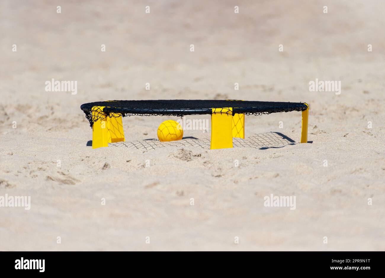 Spike ball game with yellow ball on sand. Summer game concept ...