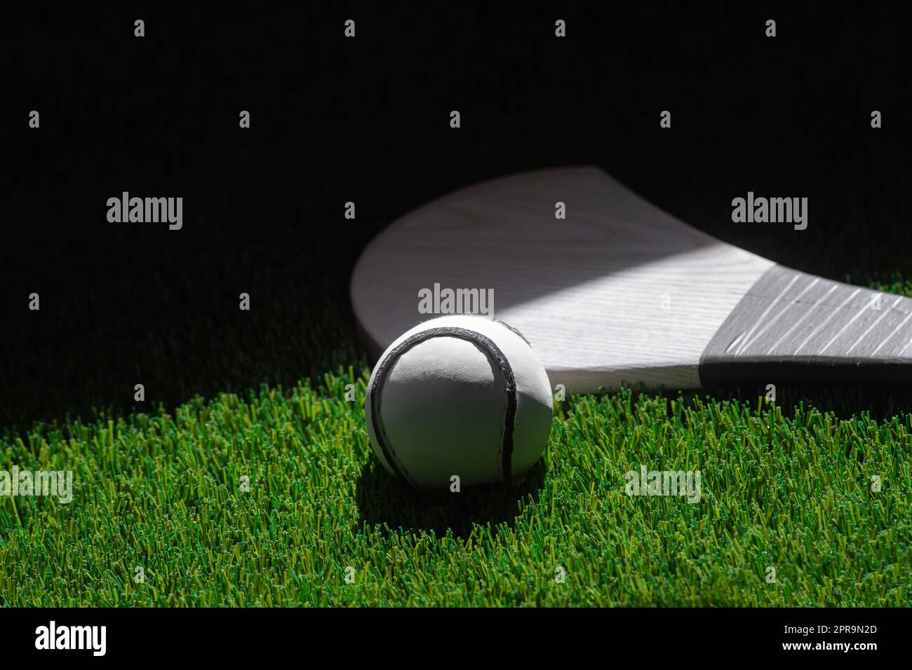 Hurling bat and sloitar on green grass. Horizontal sport theme poster ...