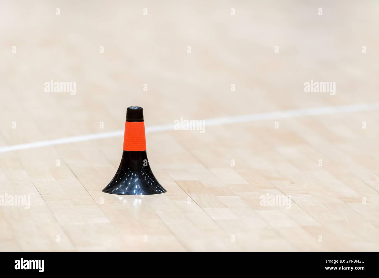Training cones on hardwood court floor. Basketball, futsal, handball ...