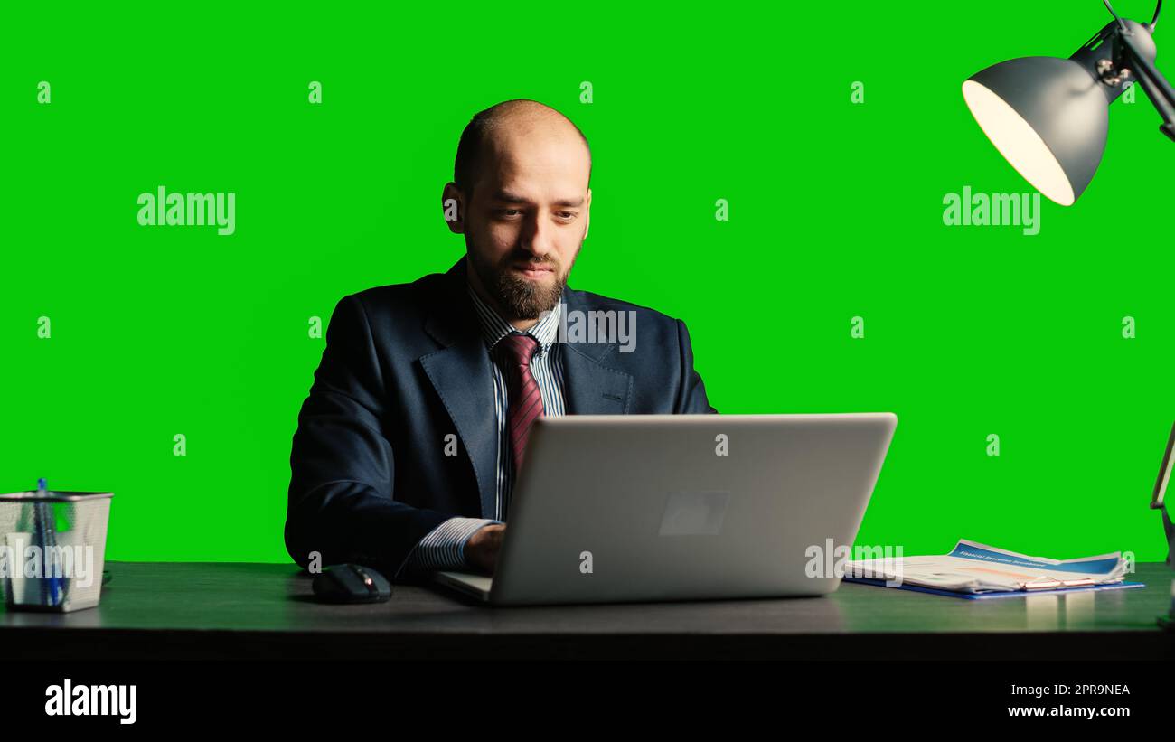 Executive manager using laptop over green screen backdrop, using ... Executive manager using laptop over green screen backdrop, using ...