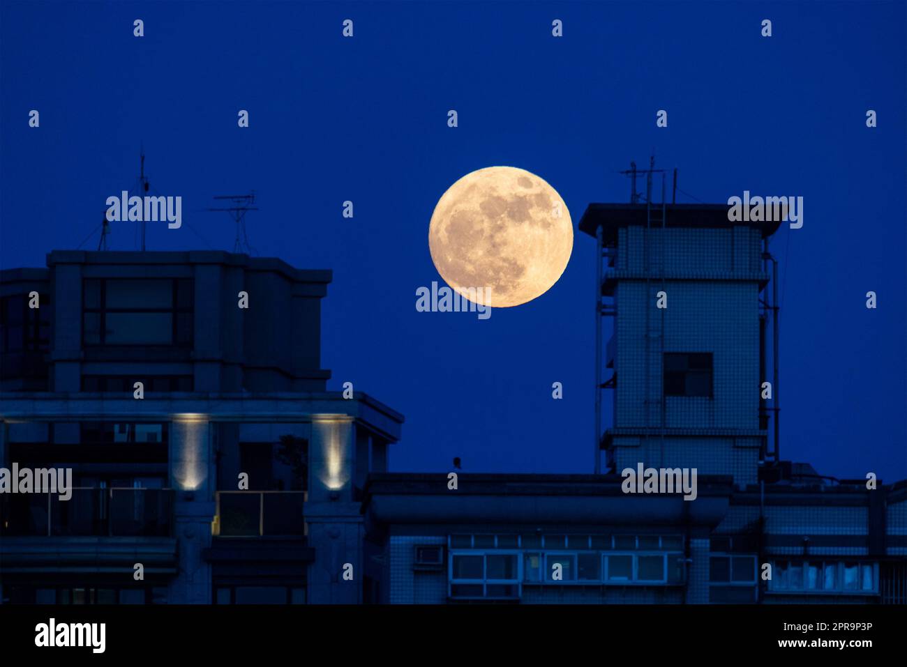 Super moon and the building Stock Photo - Alamy