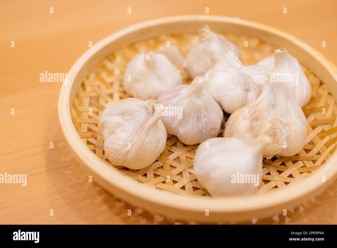 Stack of garlic on basket Stock Photo - Alamy