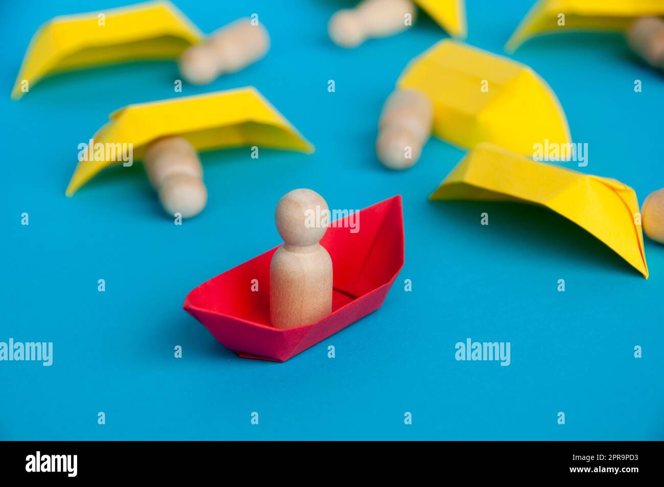 Leadership failure concept - People figure on yellow paper ship origami ...