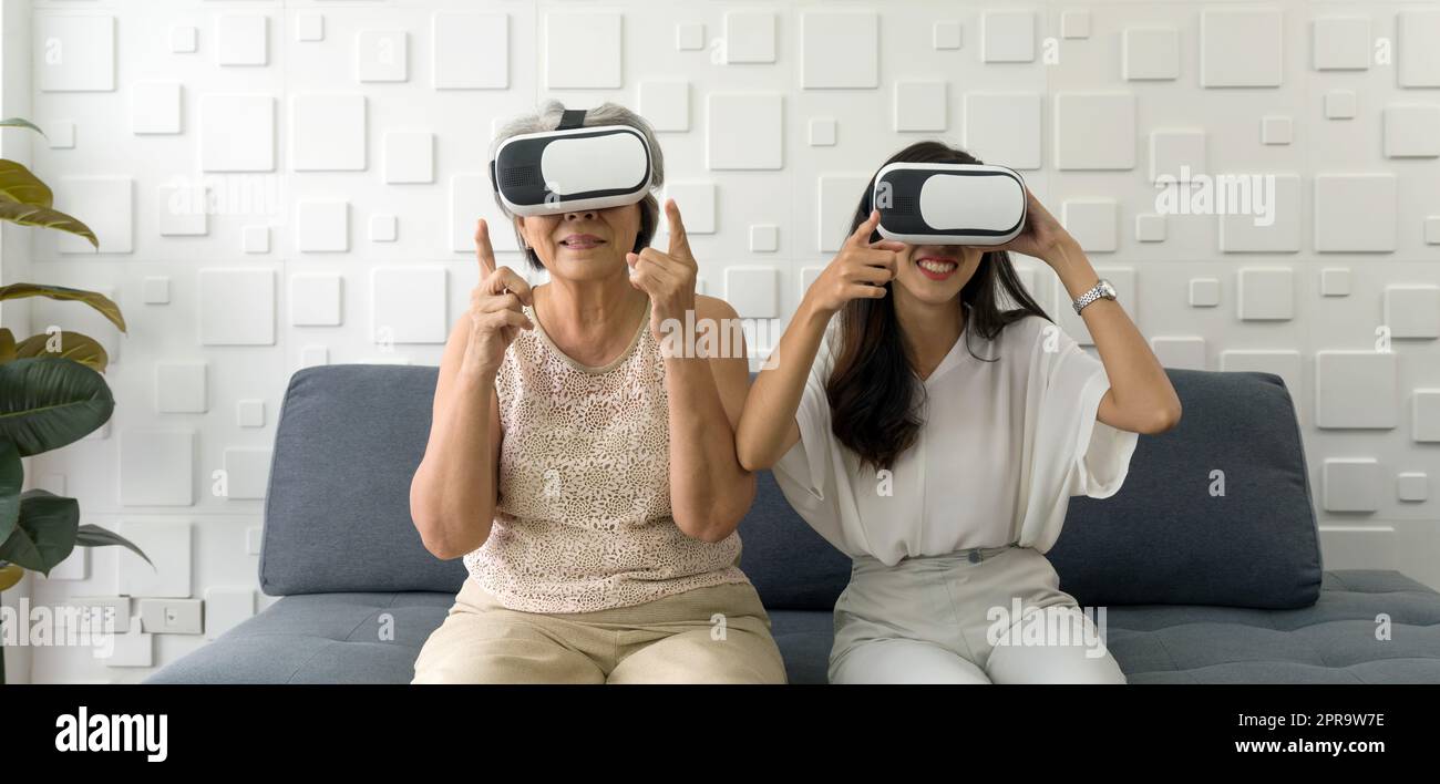 Happy family living together, asian woman and her grandmother play an ...