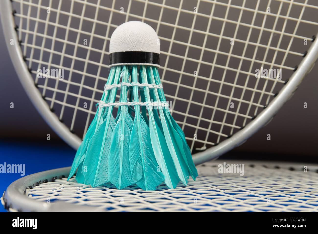 Badminton feather shuttlecocks near rackets Stock Photo - Alamy