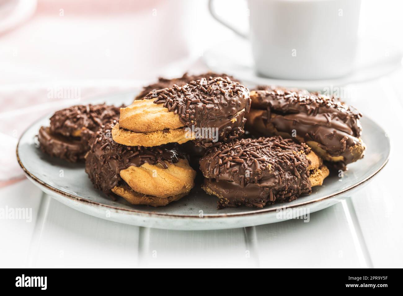 Petit fours with chocolate sprinkles. Mini chocolate dessert on plate ...
