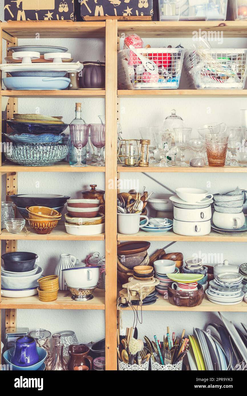 Shelves with kitchen clutter, utensils and kitchenware Stock Photo - Alamy