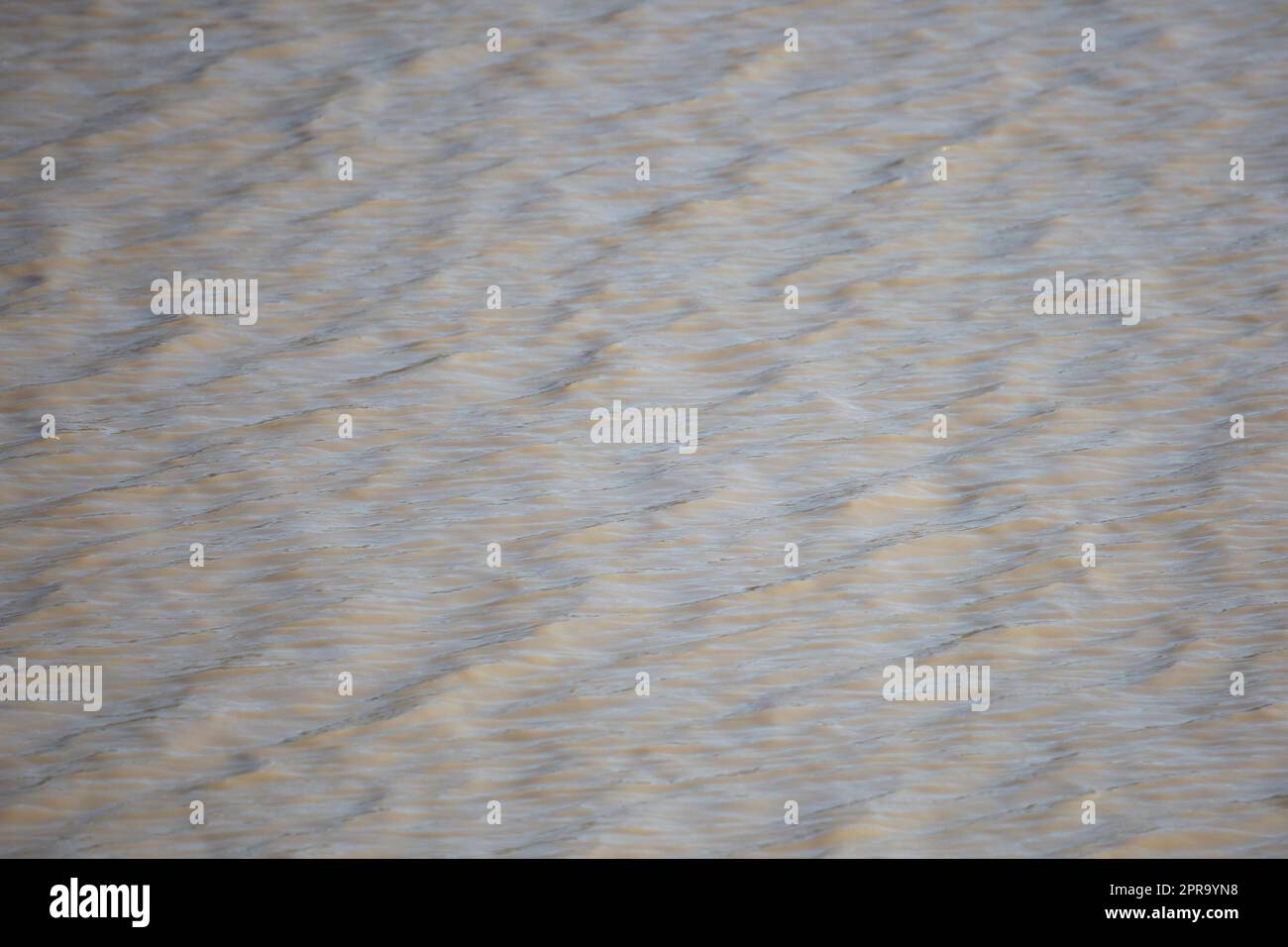 Small Waves in Muddy Water Stock Photo - Alamy