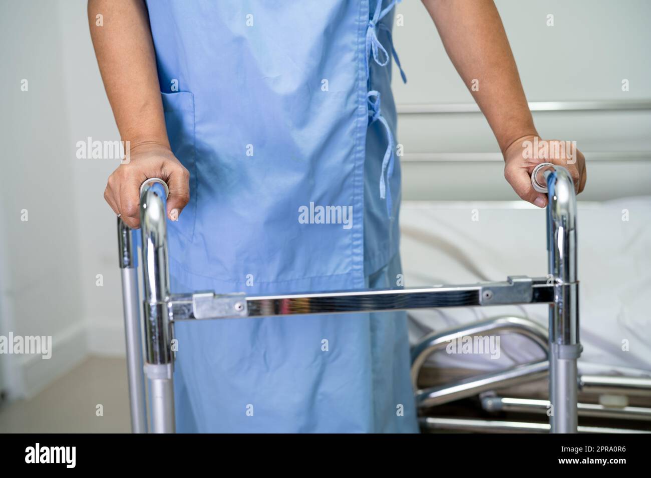 Asian lady woman patient walk with walker at nursing hospital ward ...