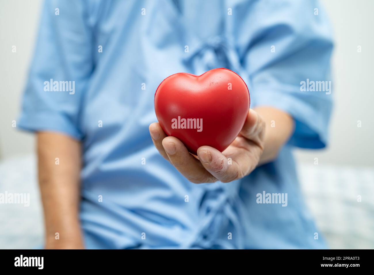 Asian senior or elderly old lady woman patient holding red heart ...
