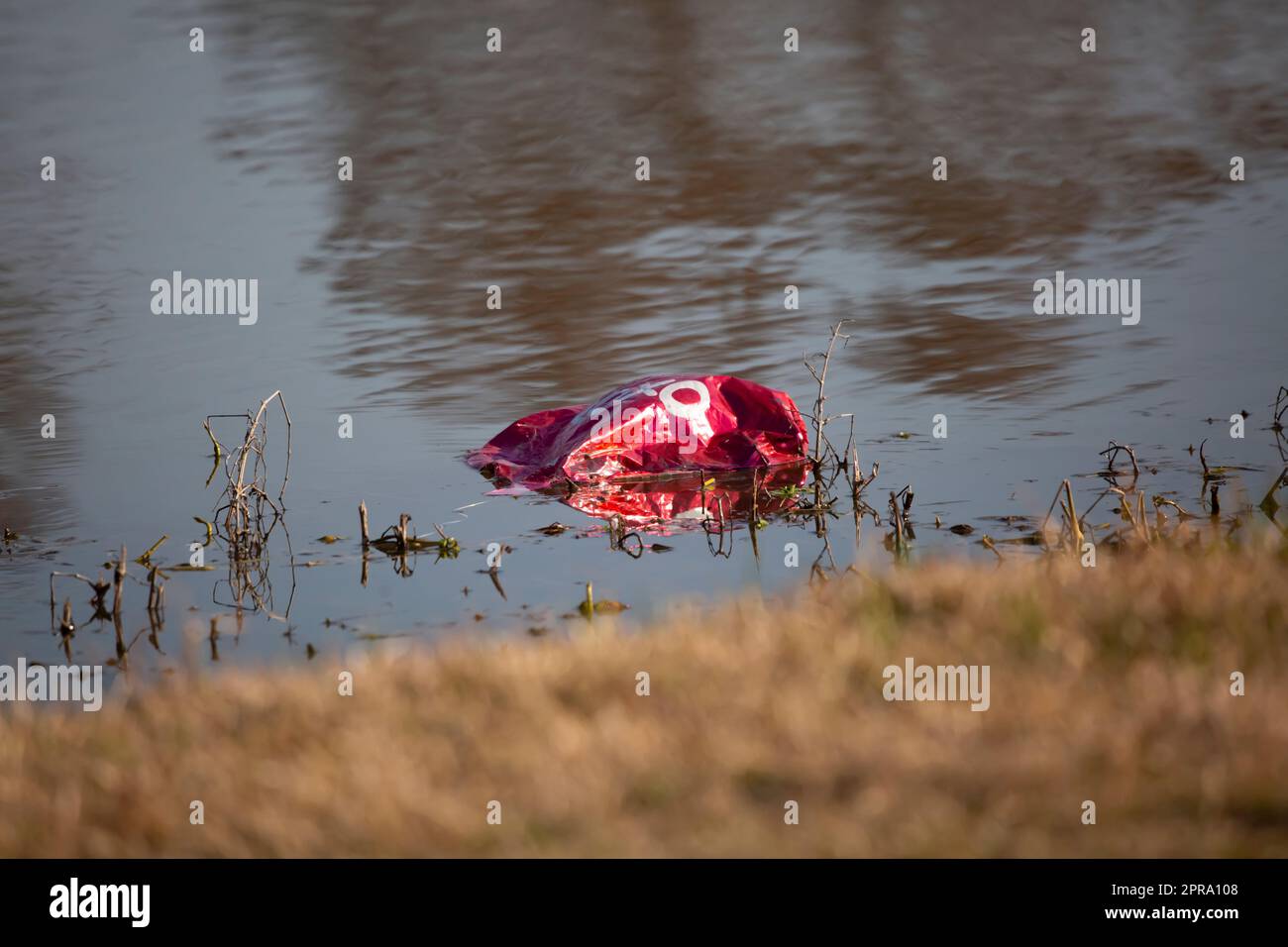 Deflated Red Balloon Stock Photo - Alamy
