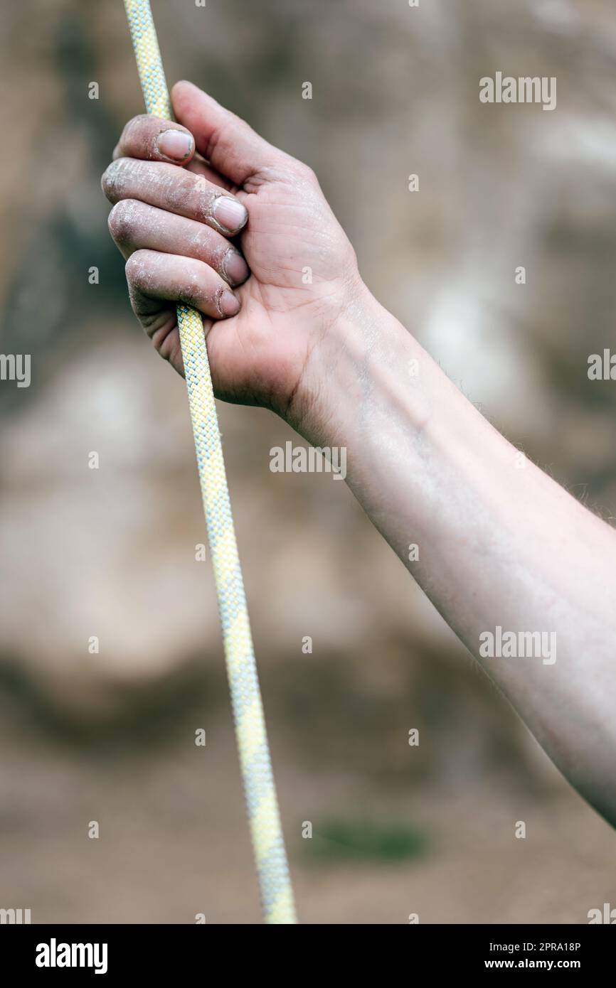 Hand holding a rock climbing rope Stock Photo - Alamy
