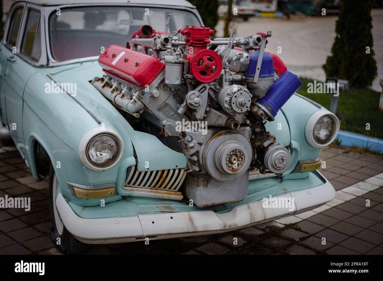 Vintage tuned car, with a large engine sticking out of its hood Stock ...