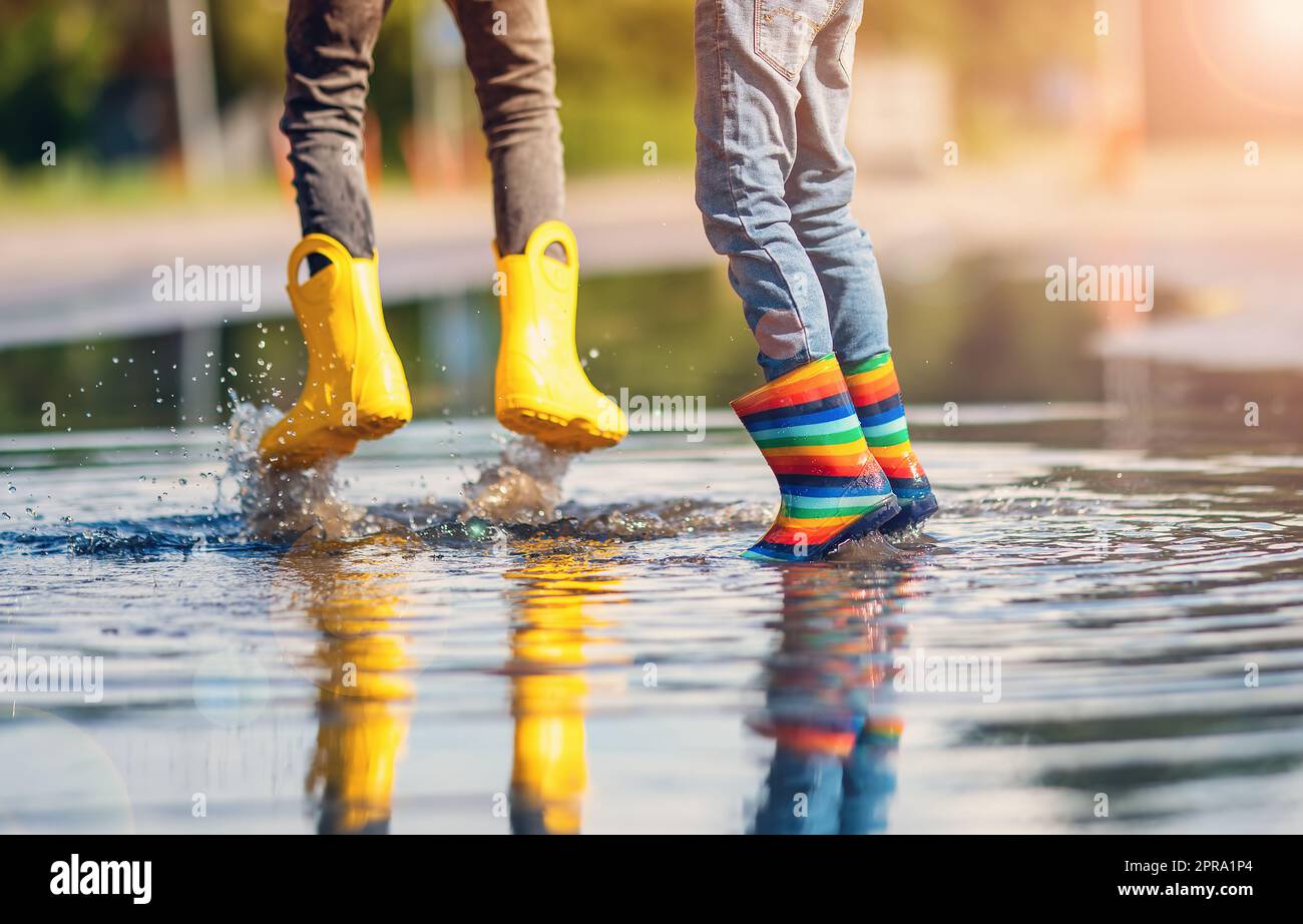 Child jumping puddle hi-res stock photography and images - Alamy