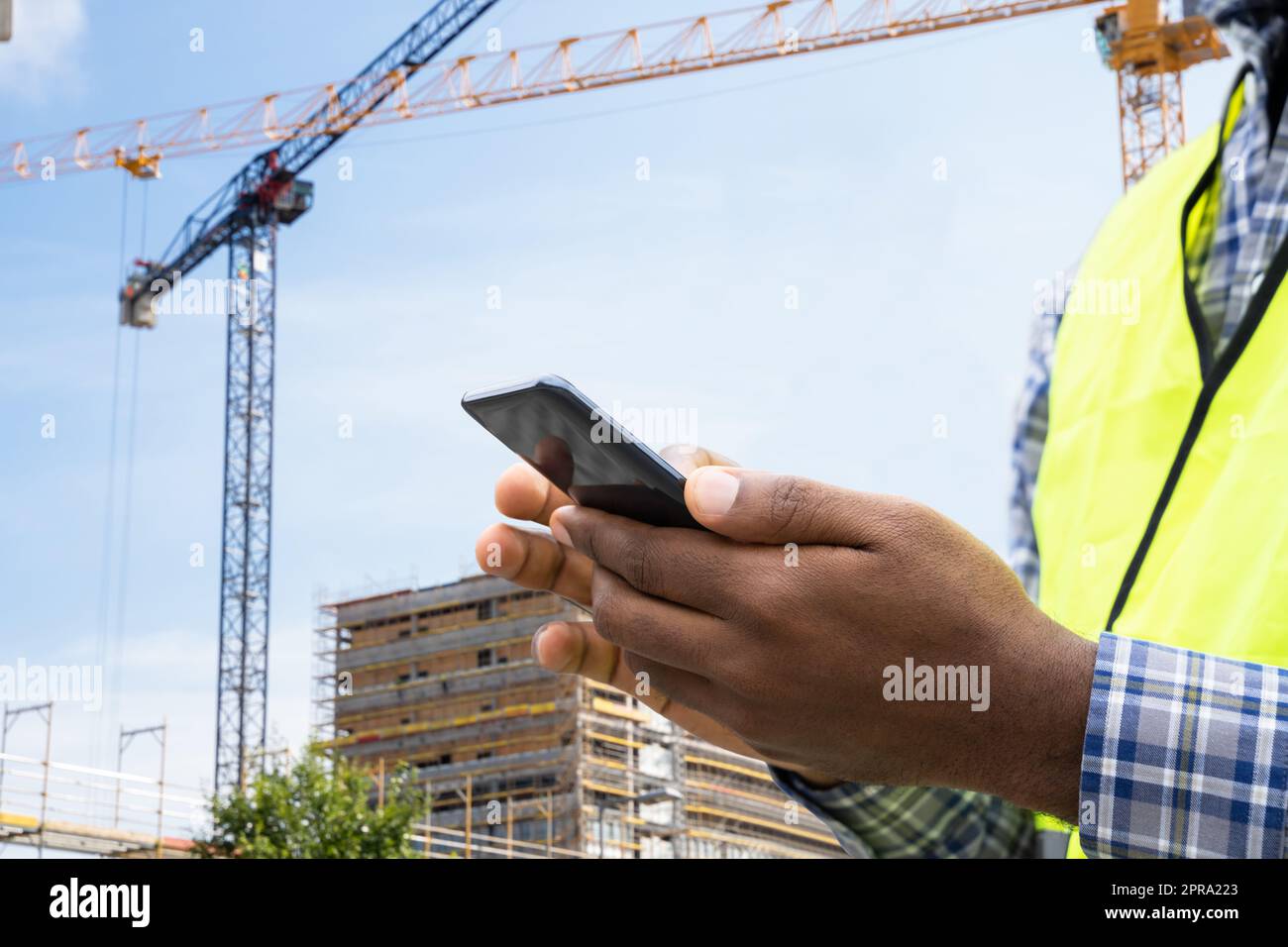 Male builder using smartphone worker hi-res stock photography and ...