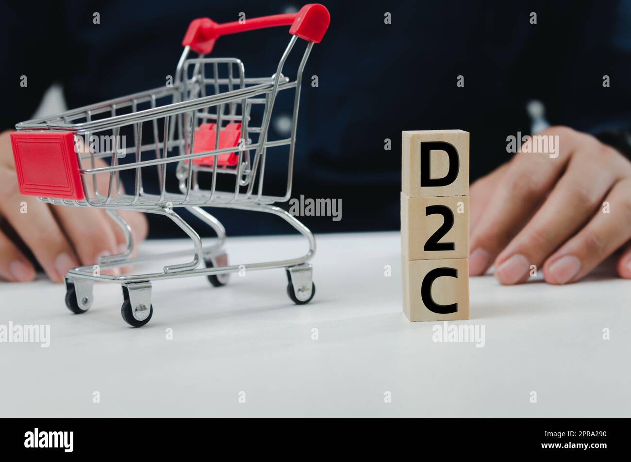 Wood cube block D2C symbol direct to consumer on table Stock Photo - Alamy