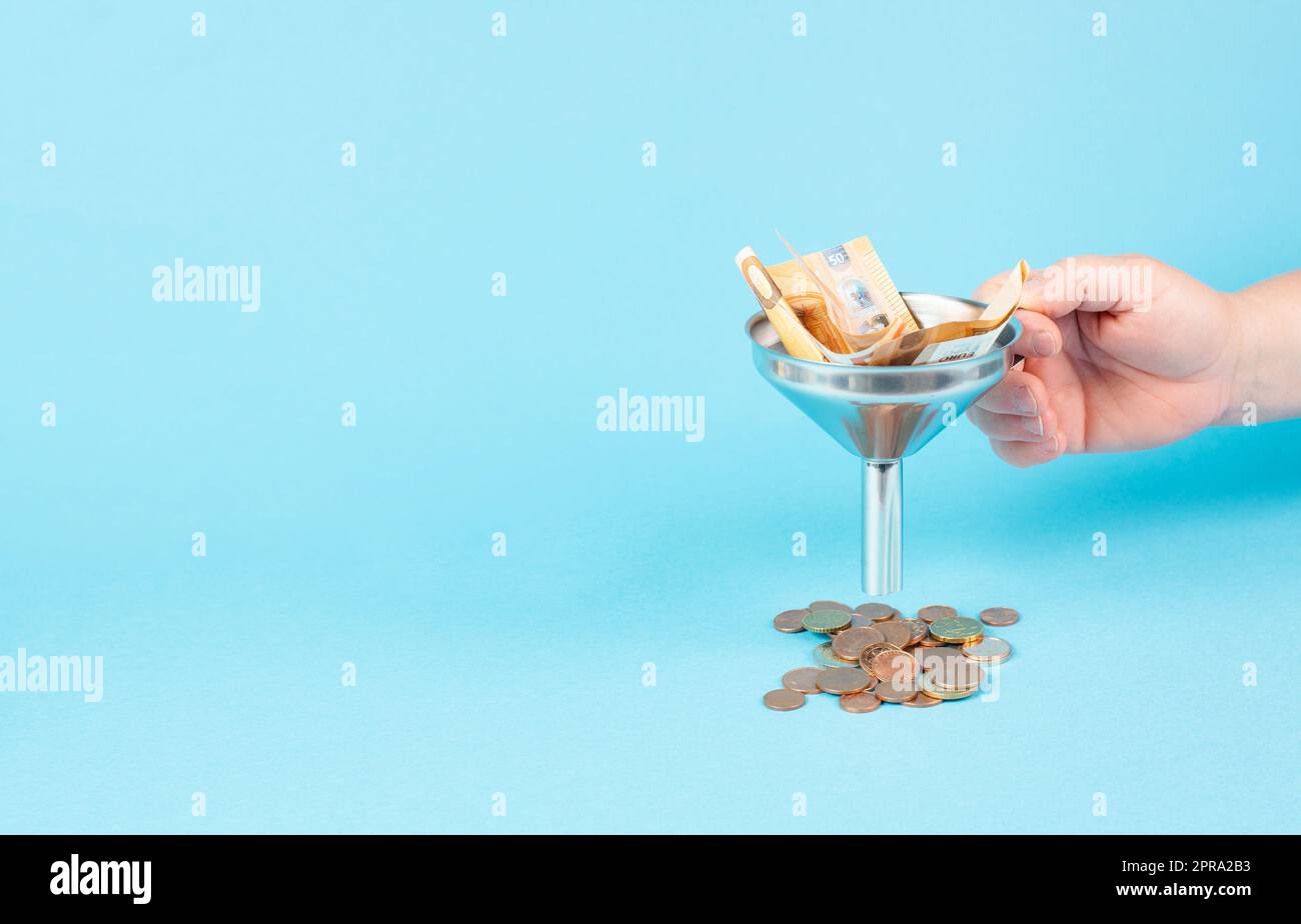 Inflation and financial crash, euro banknotes in a funnel become coins ...