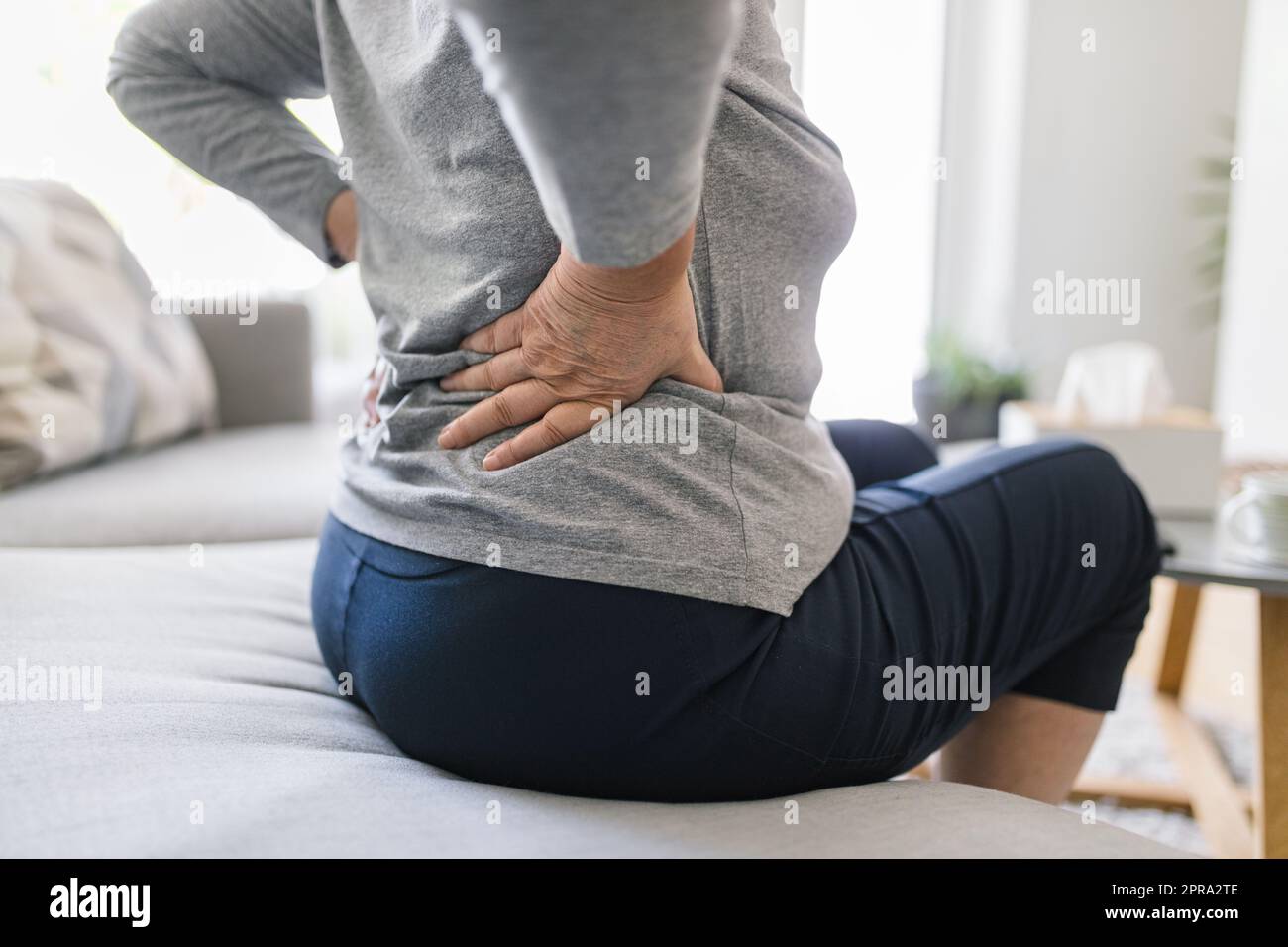 Elderly woman at home with back pain Stock Photo - Alamy