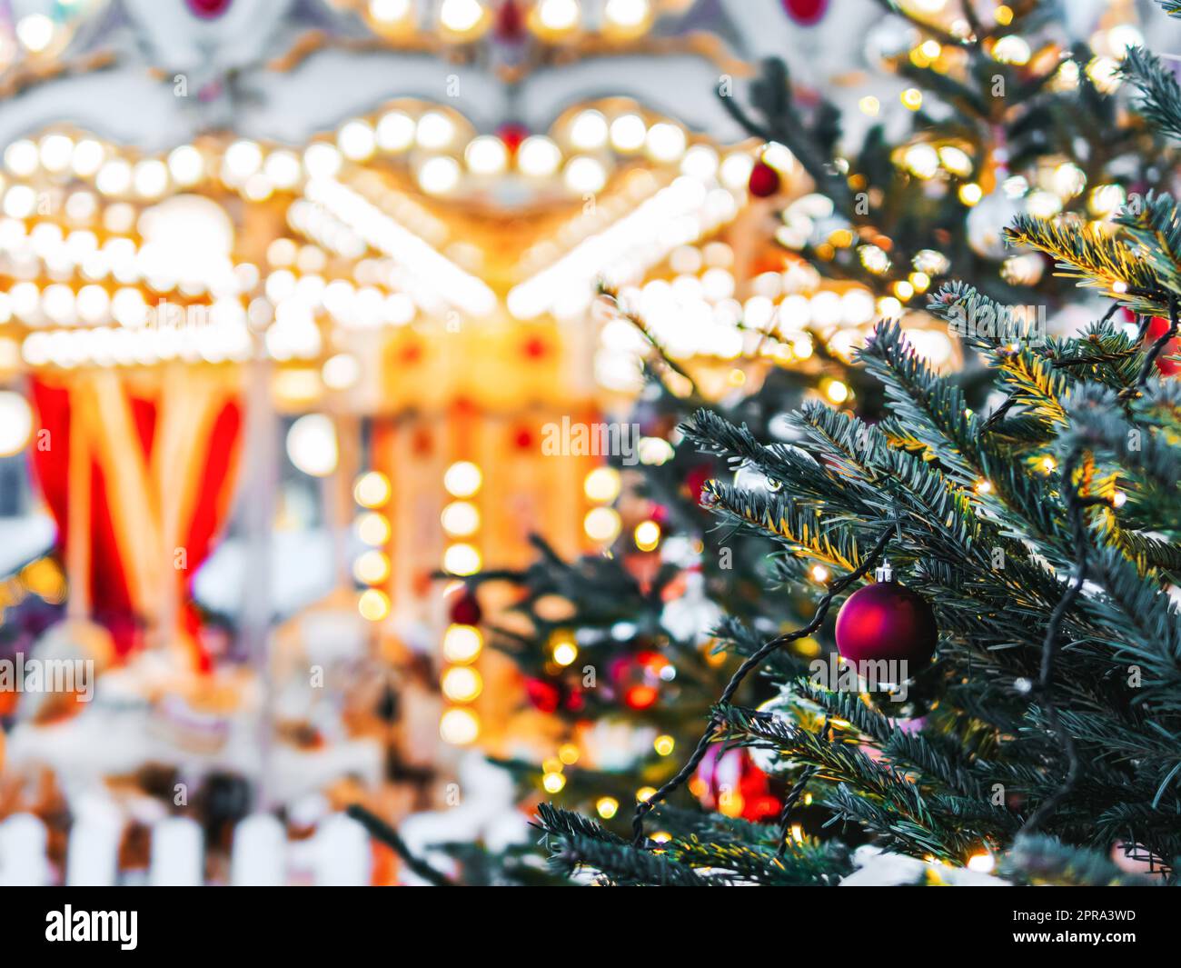 Christmas tree, blurred carousel merry go round Stock Photo - Alamy