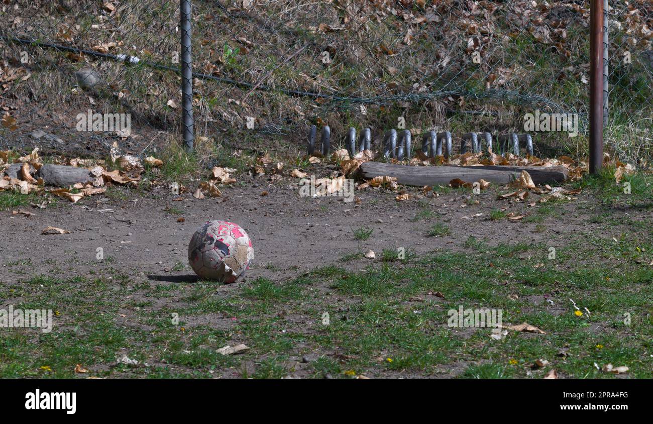 Old dirty football lying on the abandoned playground. Parts of the old ...