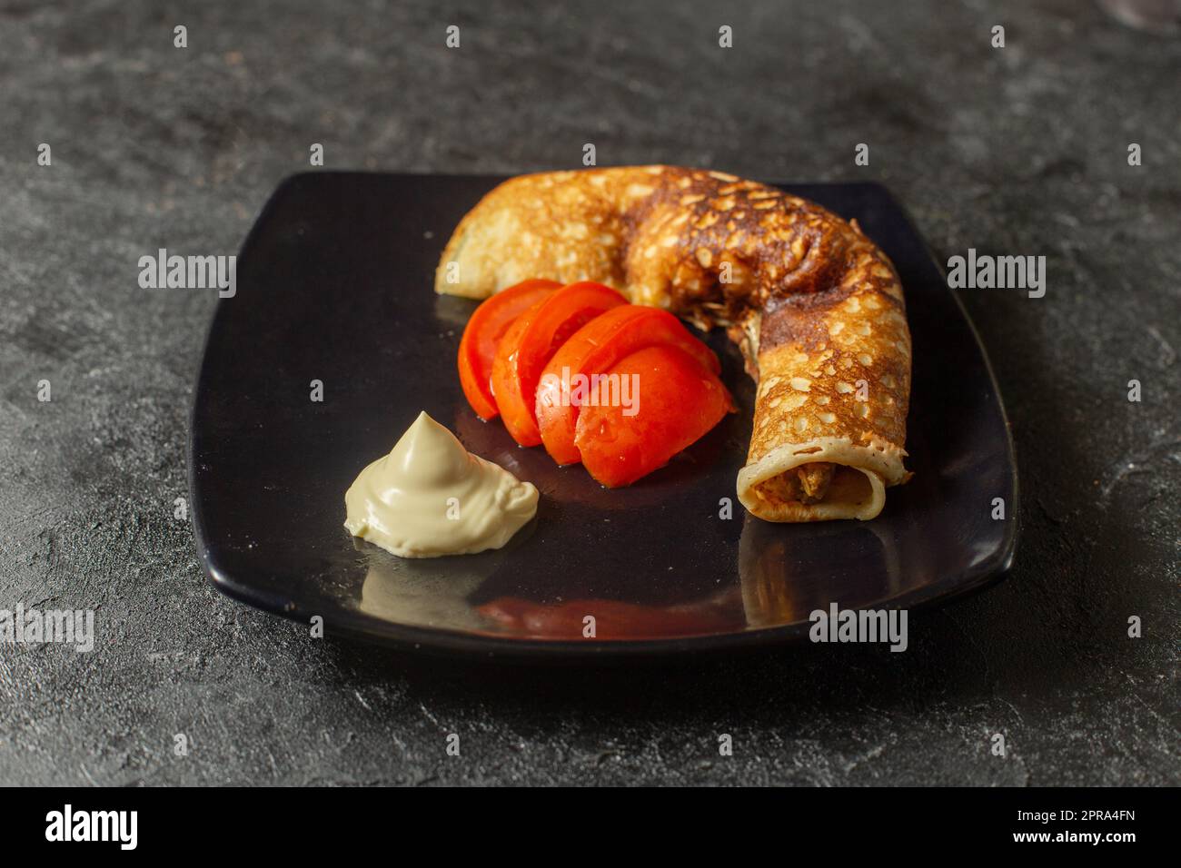 front view delicious pancakes rolled along with sliced tomatoes and ...