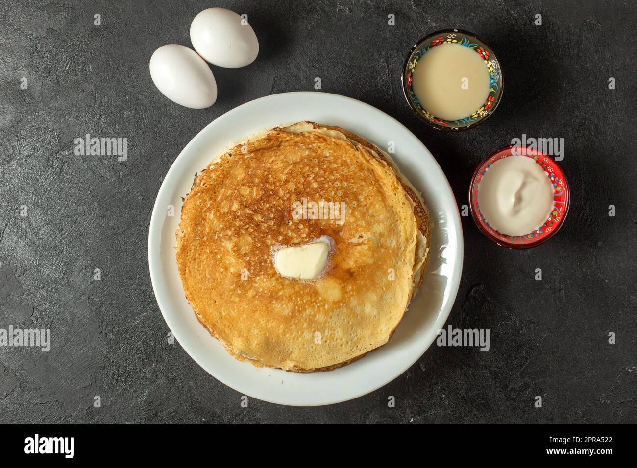 top view baked delicious pancakes inside white plate with milk and eggs ...