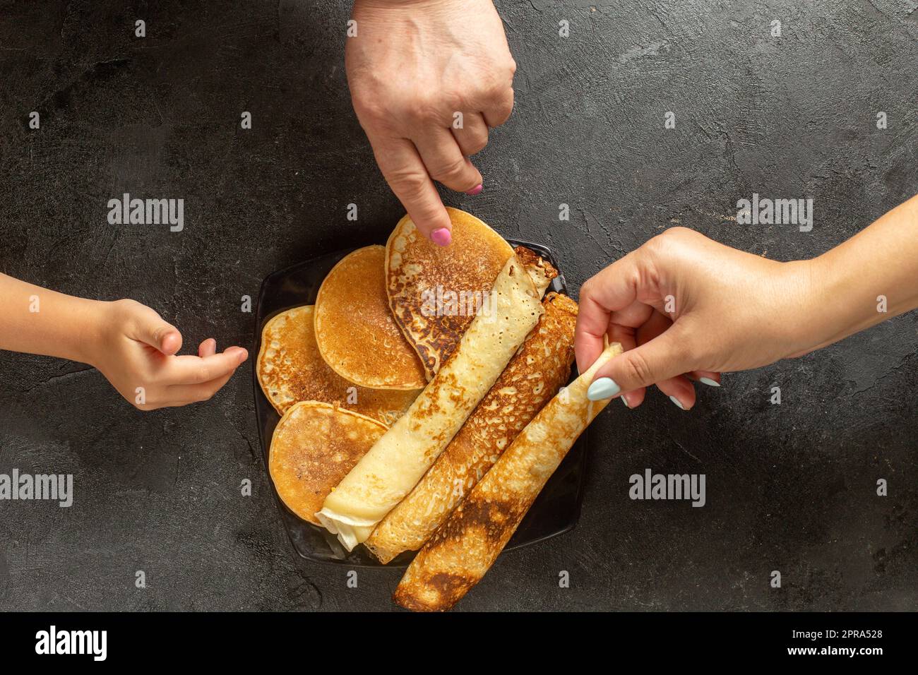 top view delicious baked pancakes inside black plate taking by people ...