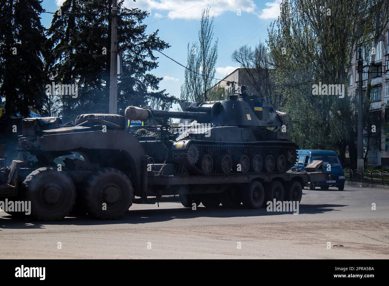 A Ukrainian army truck carries a self-propelled howitzer, a wheeled ...