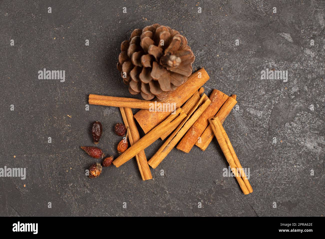 top view brown cinnamon tubule formed on the dark desk food cinnamon ...