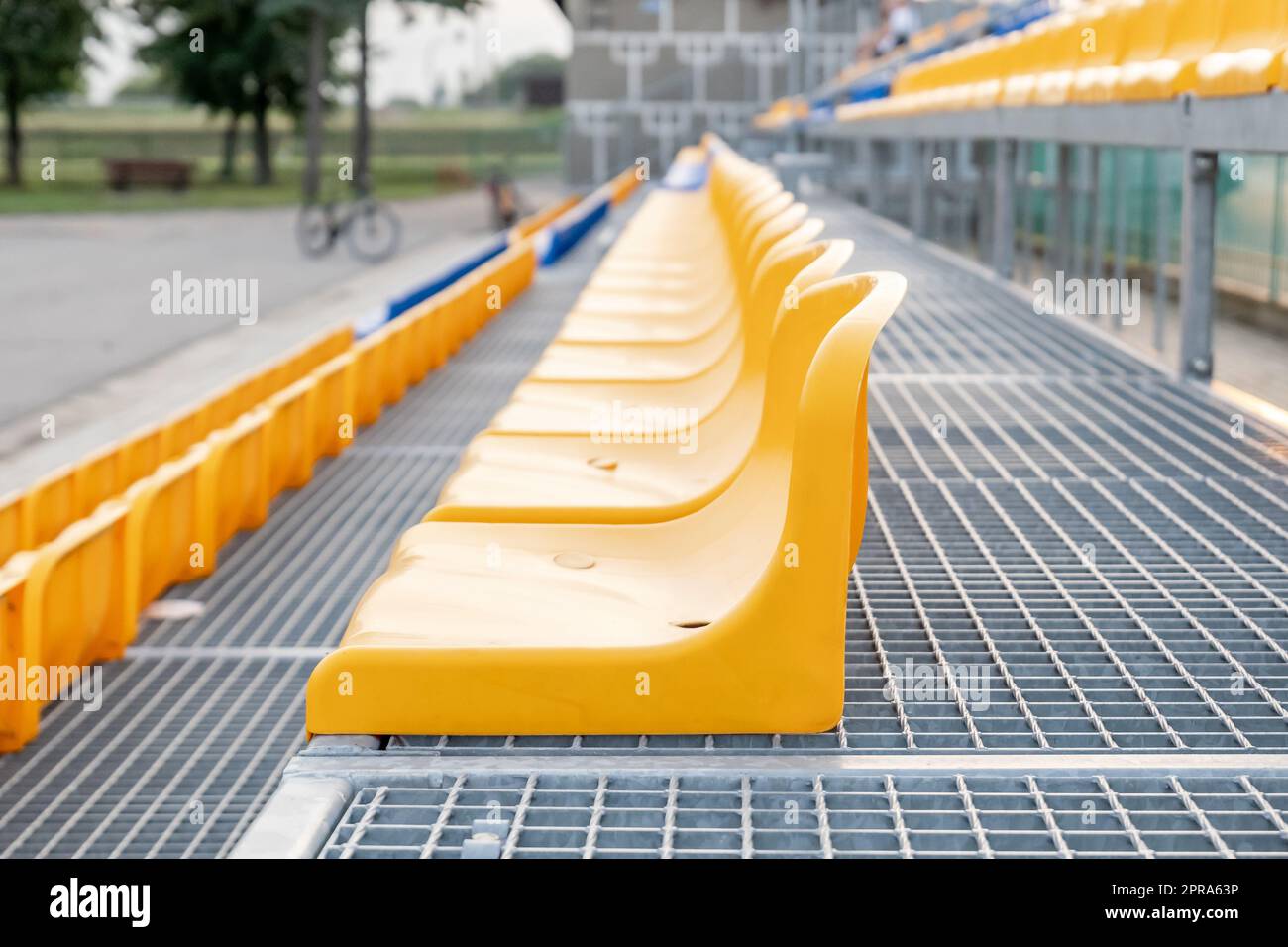 Simple empty vacant small stadium seats outdoors, bleachers, nobody, no ...