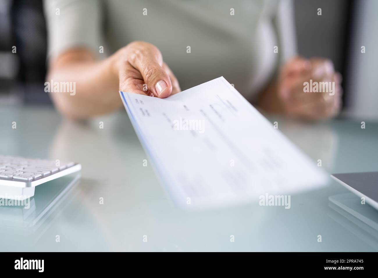 Giving Paycheck Or Payroll Cheque Stock Photo - Alamy