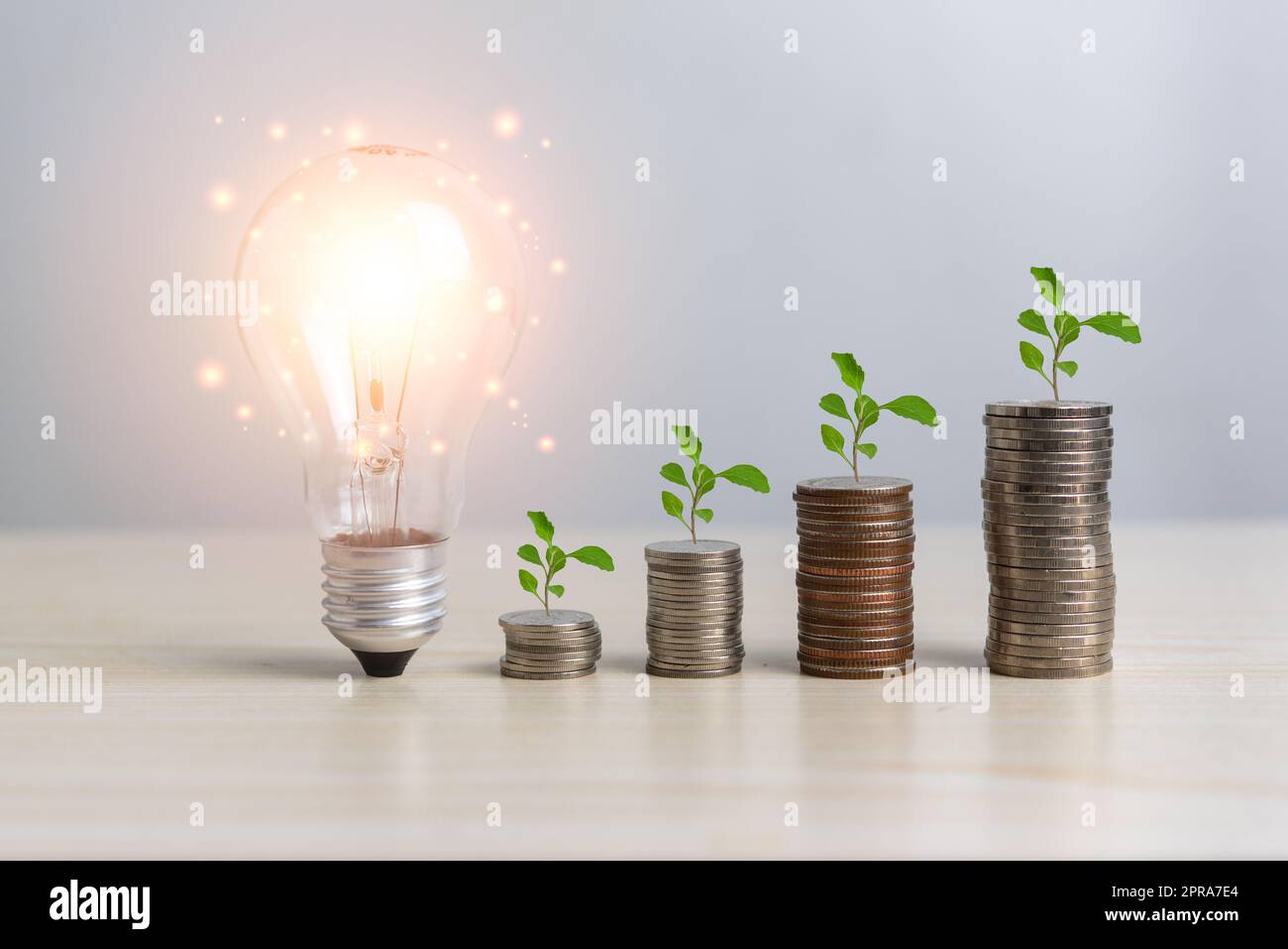 Stack money coin and tree bulb light with business graph finance ...