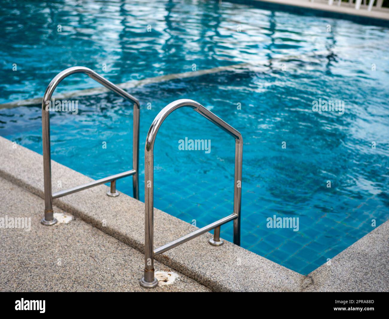 .Stainless steel stairs to the pool. handrails up and down the pool ...