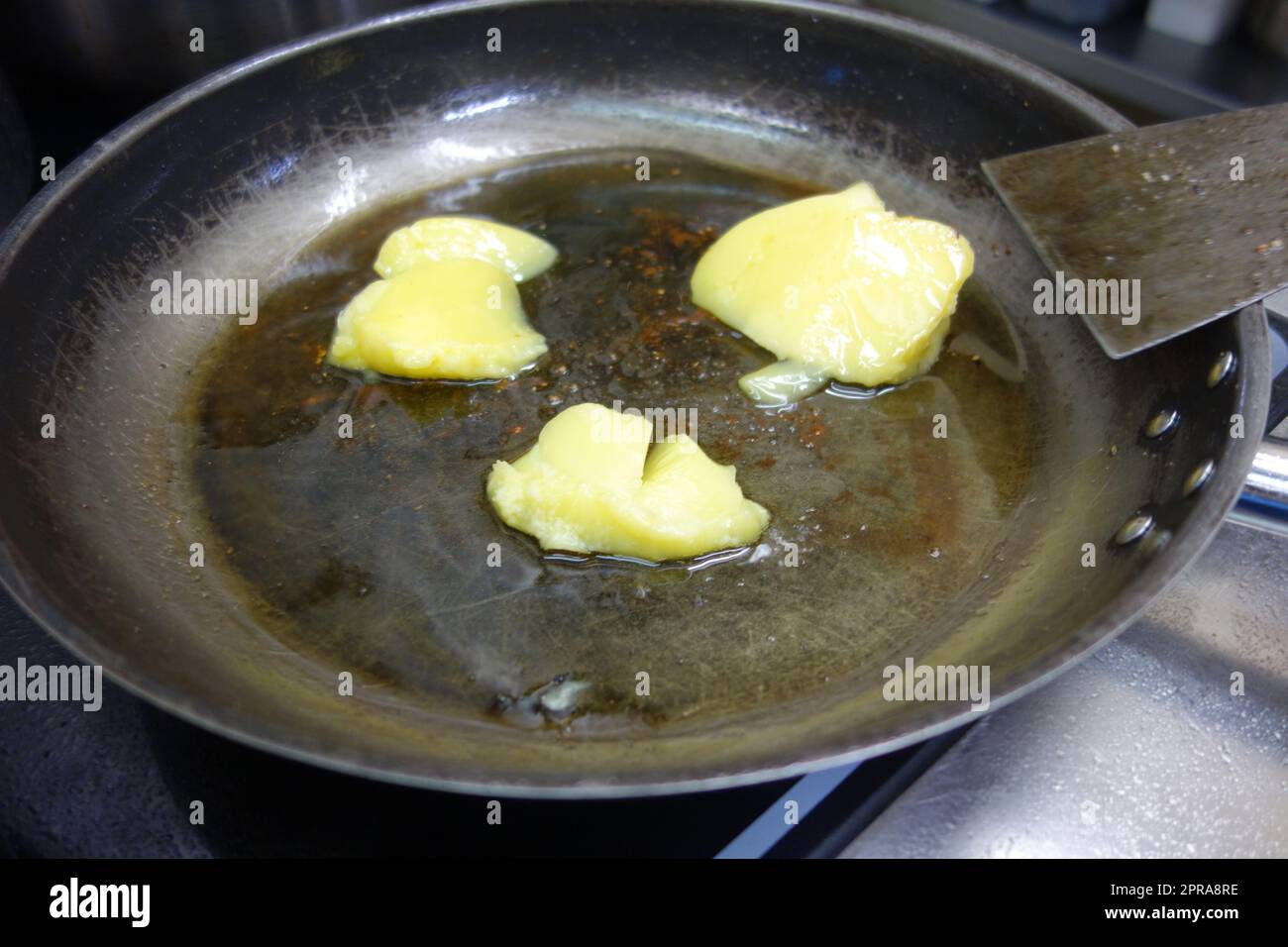 deep frying of snacks in vegetable oil in a pan Stock Photo - Alamy