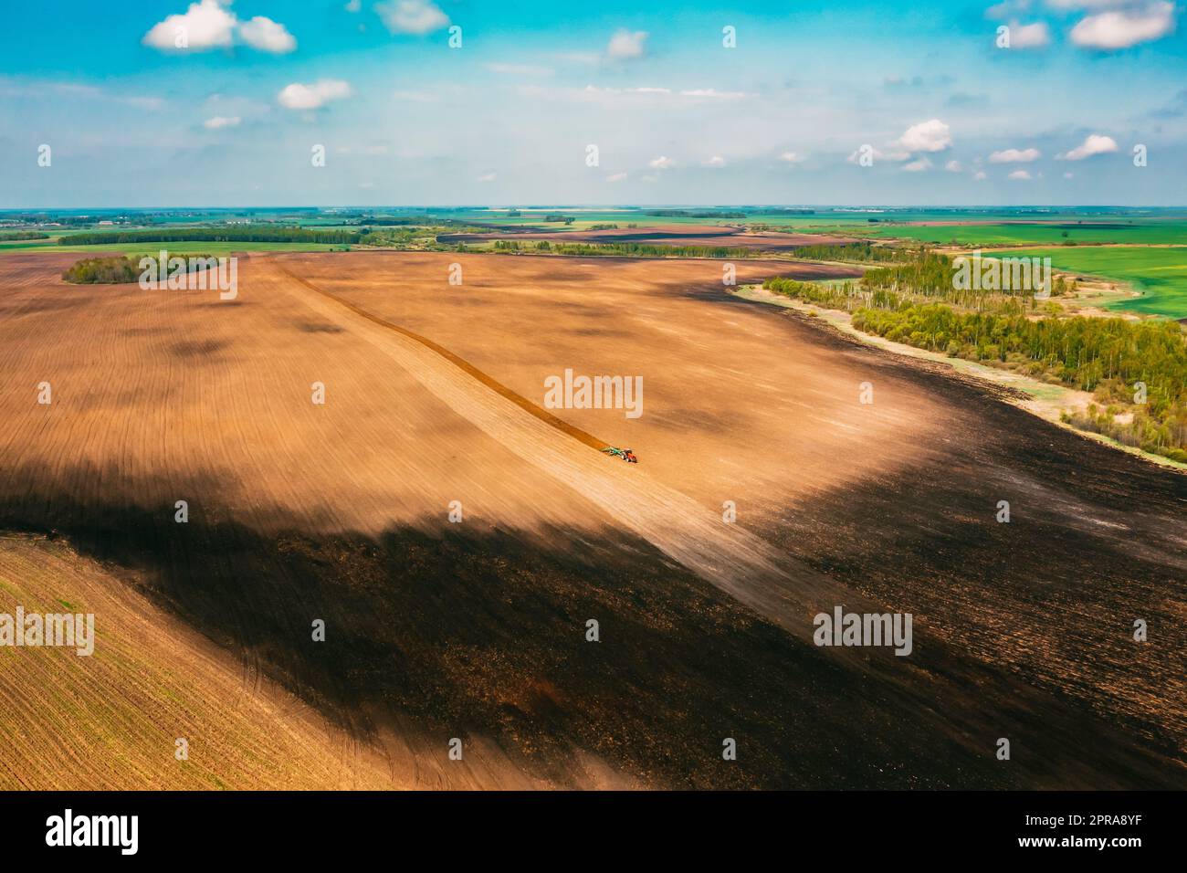 Aerial View. Tractor Plowing Field In Spring Season. Beginning Of ...