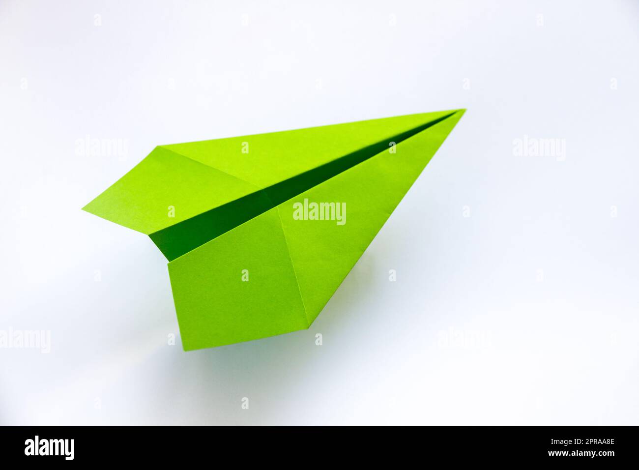 Green paper plane origami isolated on a white background Stock Photo ...
