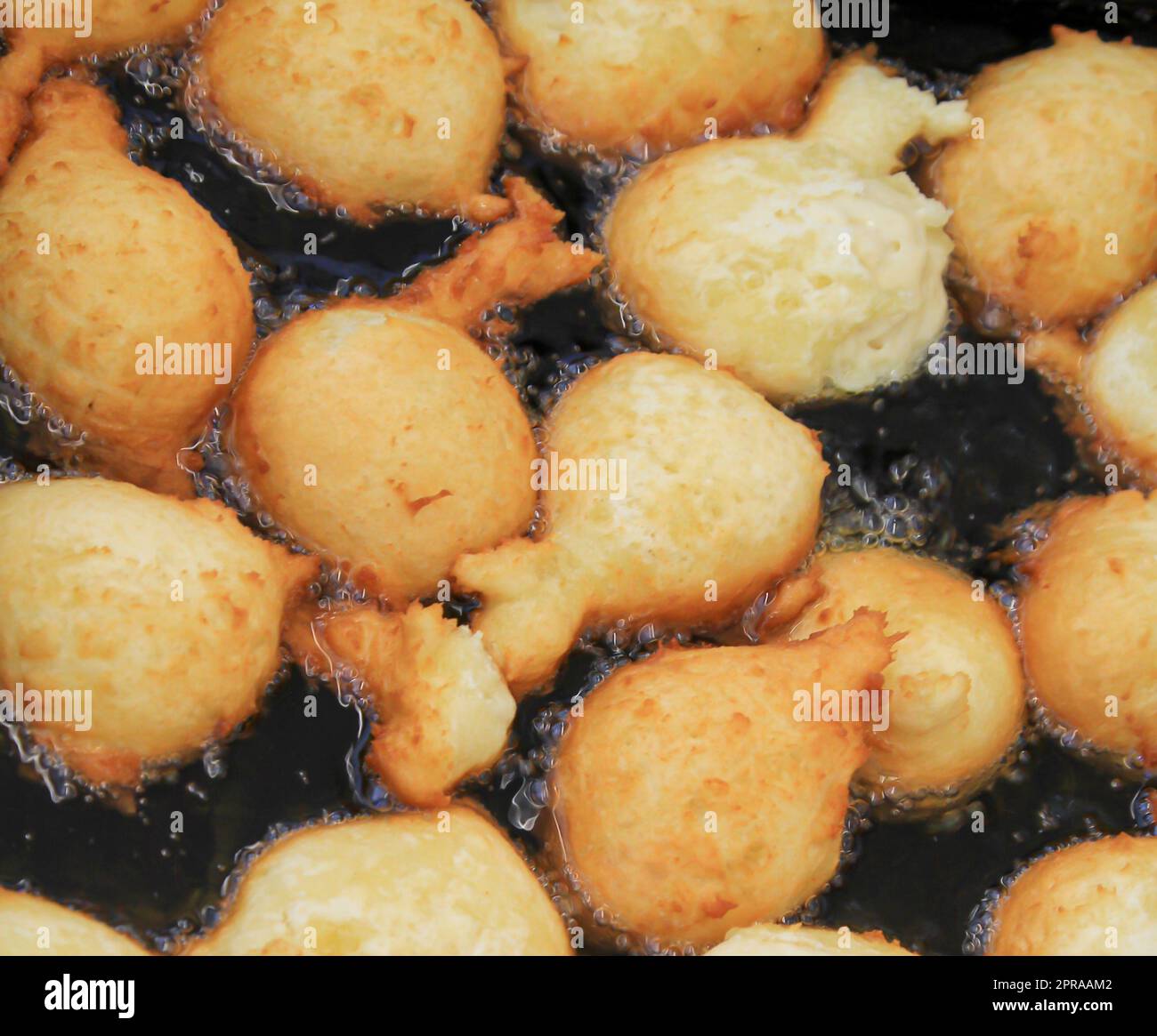A whole lot of curd balls in a boiling oil bath Stock Photo - Alamy