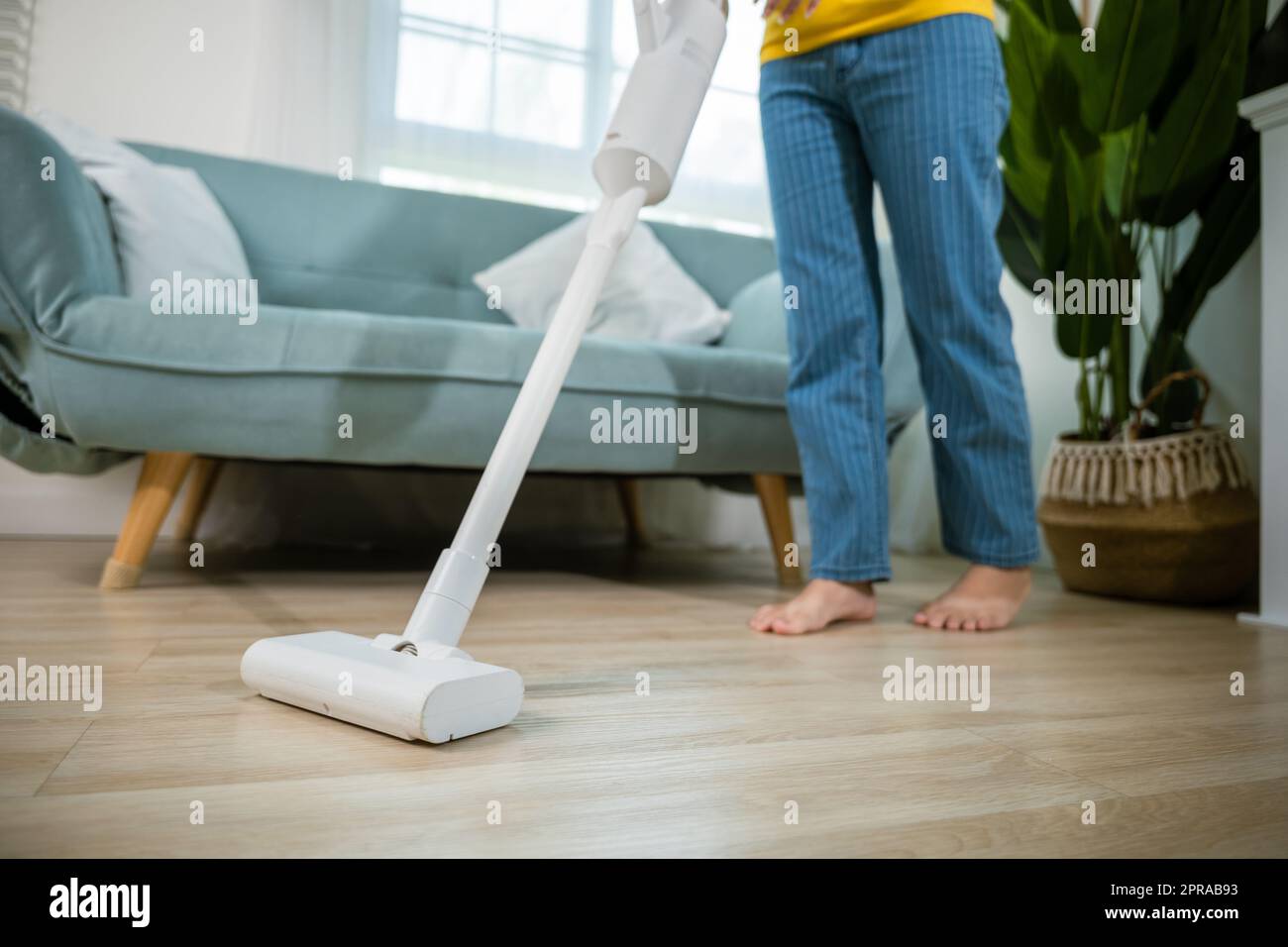 Happy Asian young woman with accumulator vacuum cleaner at home in living room Stock Photo - Alamy