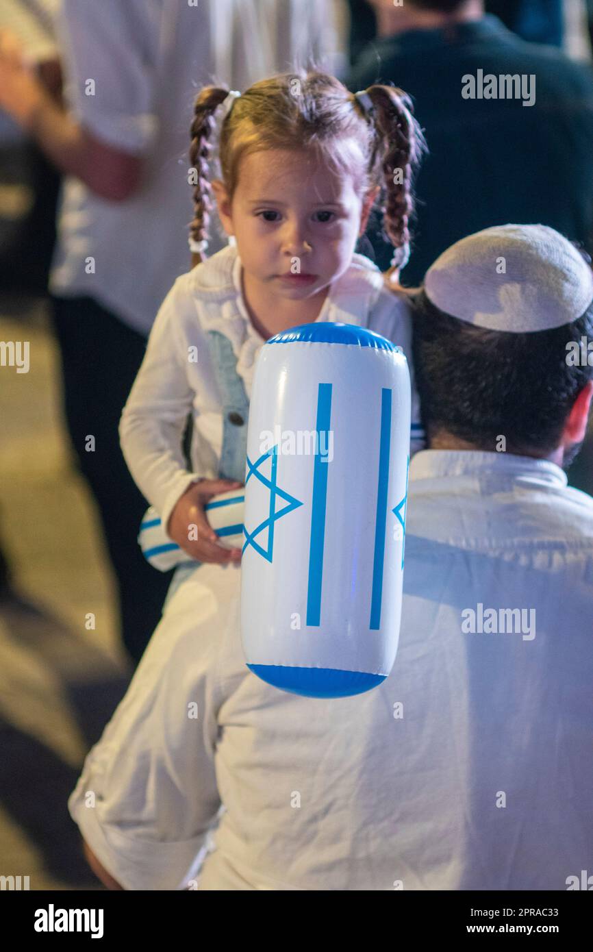Harish, Israel. A girl holds an inflatable hammer with a Israeli flag ...