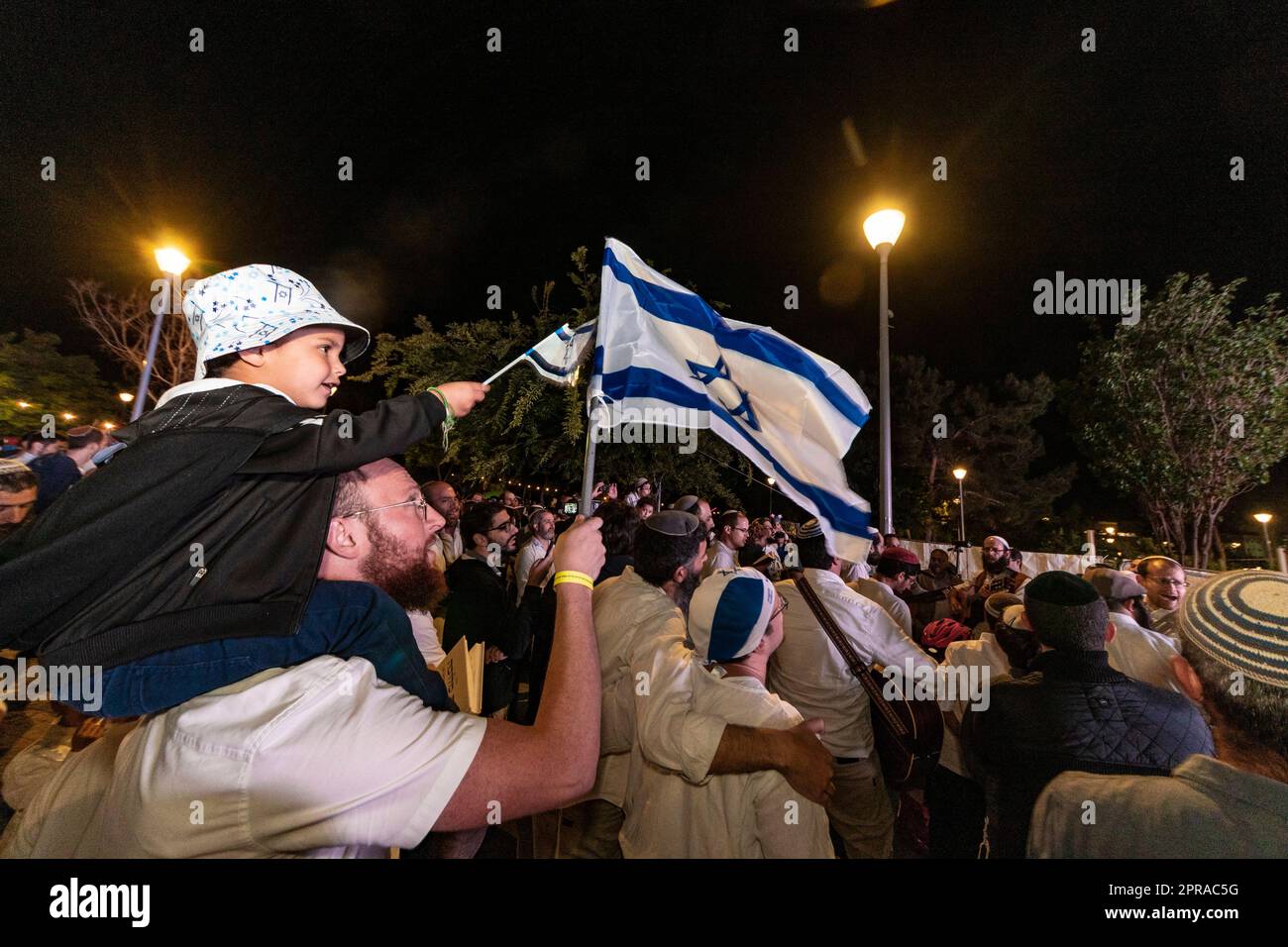 Harish, Israel. A child holds a Israeli flag during independence day ...