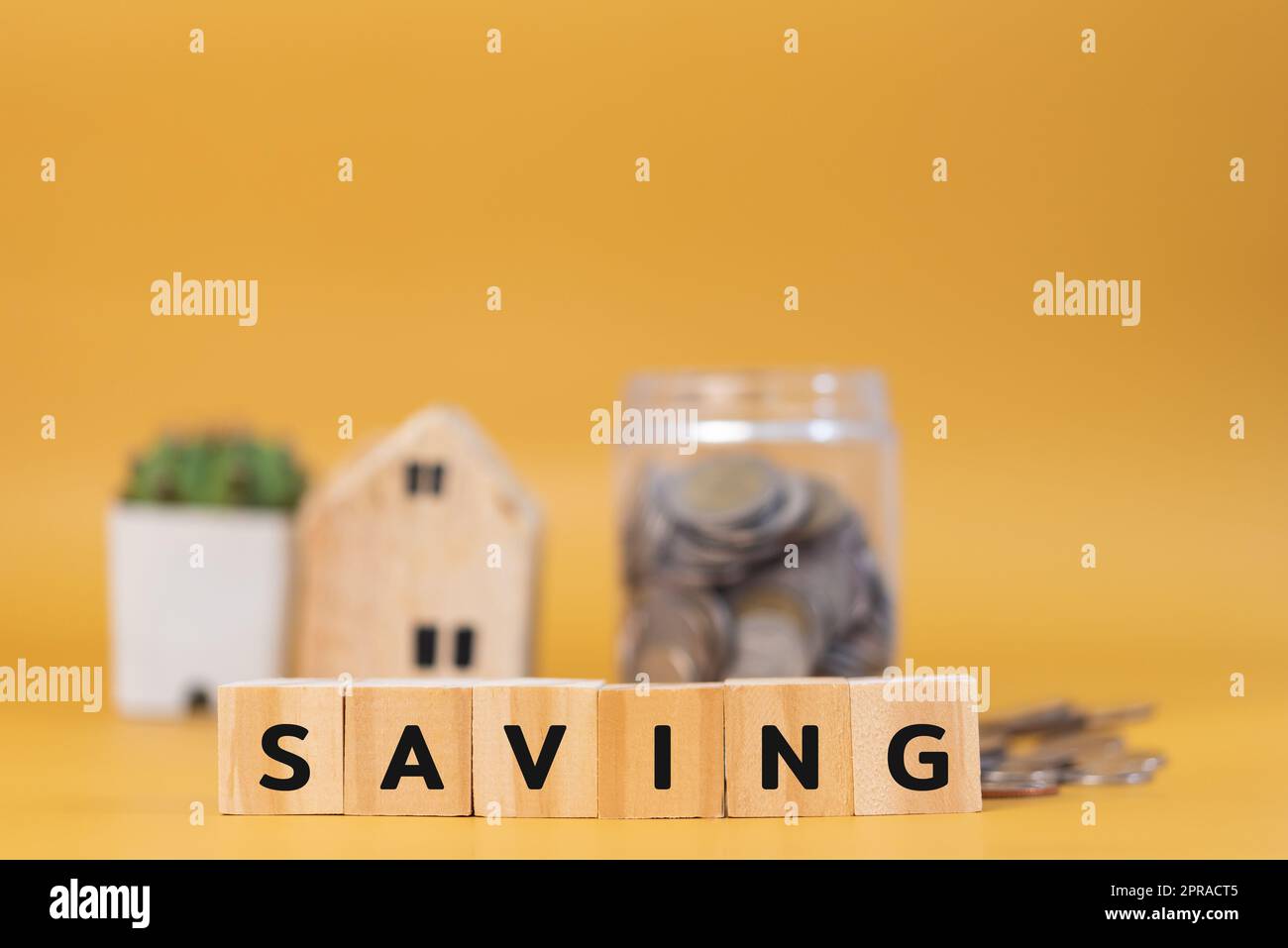 wood cube block saving on yellow background.Business finance investment ...
