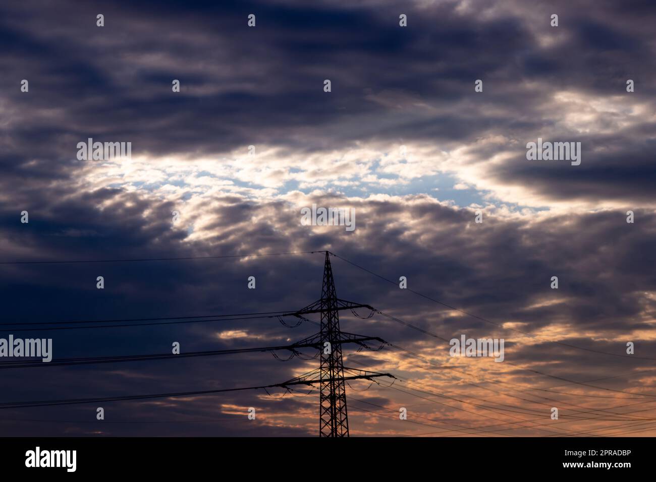 Golden sky with sun rays and lens flare shows solar energy with ...