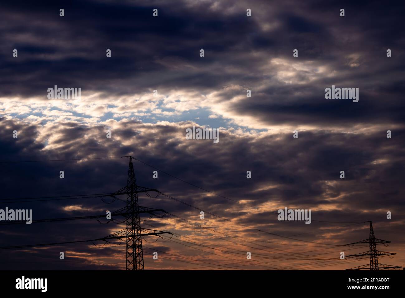 Golden sky with sun rays and lens flare shows solar energy with ...