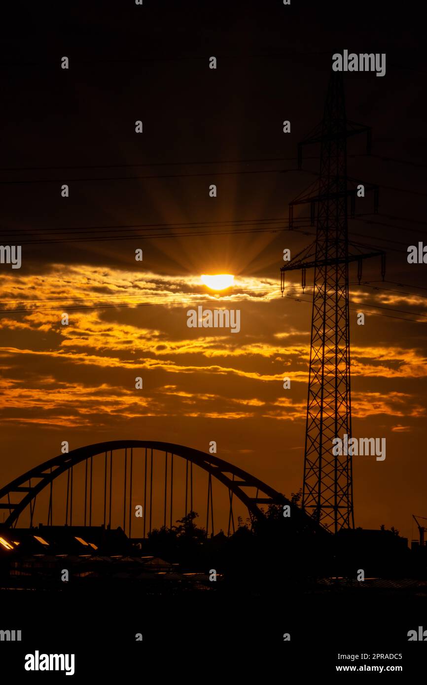 Golden sky with sun rays and lens flare shows solar energy with ...