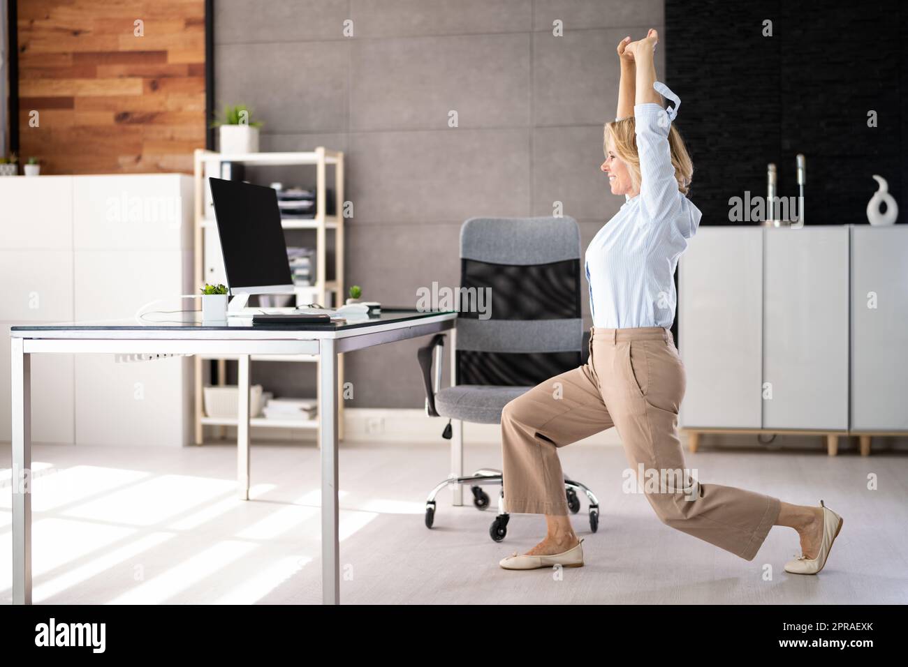 Employee Doing Split Squat Stock Photo - Alamy