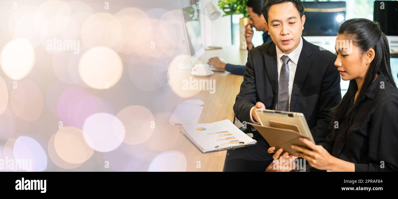 Two business people having meeting together discussing the charts and ...